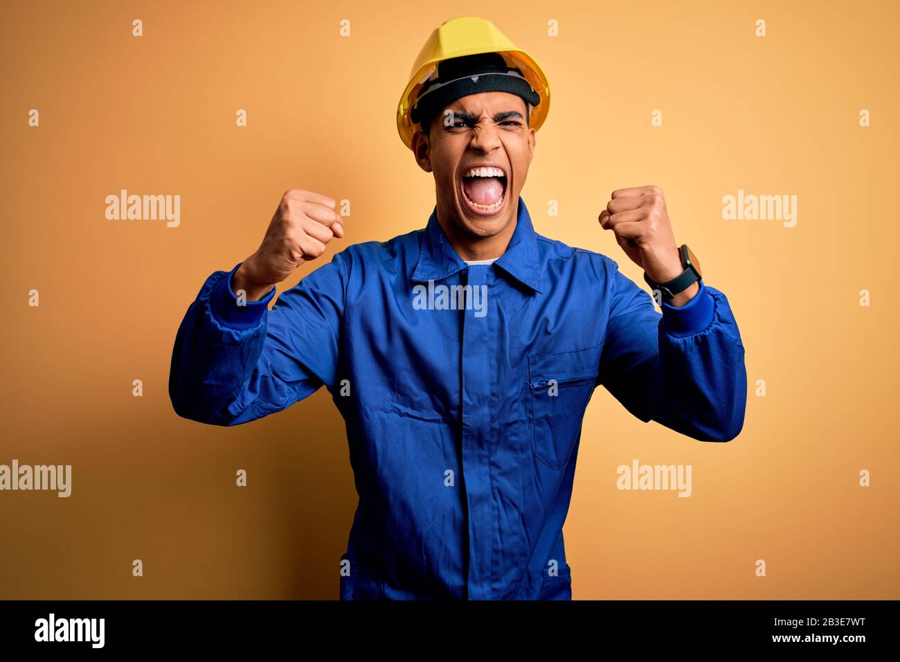 Young handsome african american worker man wearing blue uniform and ...