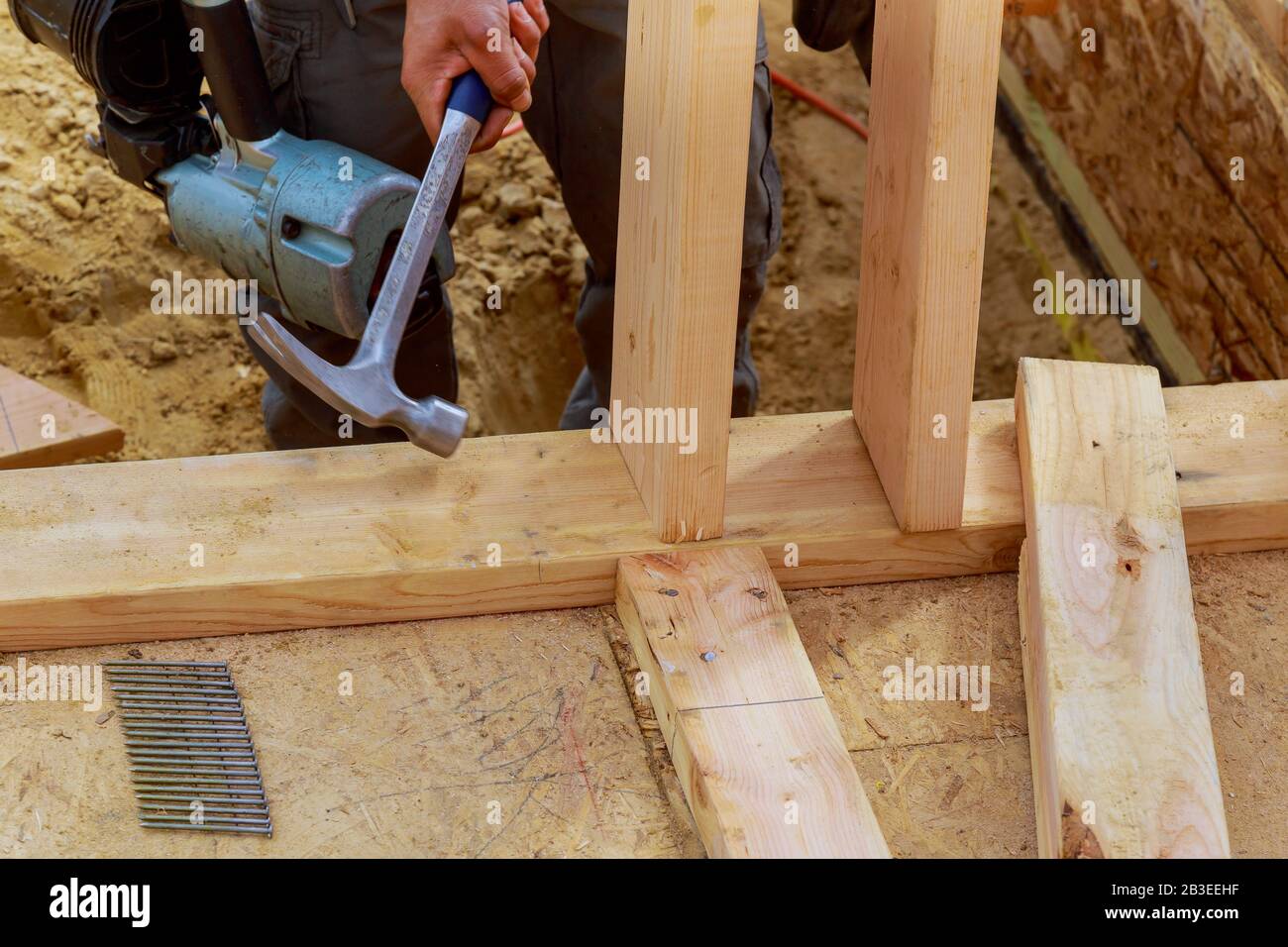 Contractor framing up wall section for a framing building custom house ...