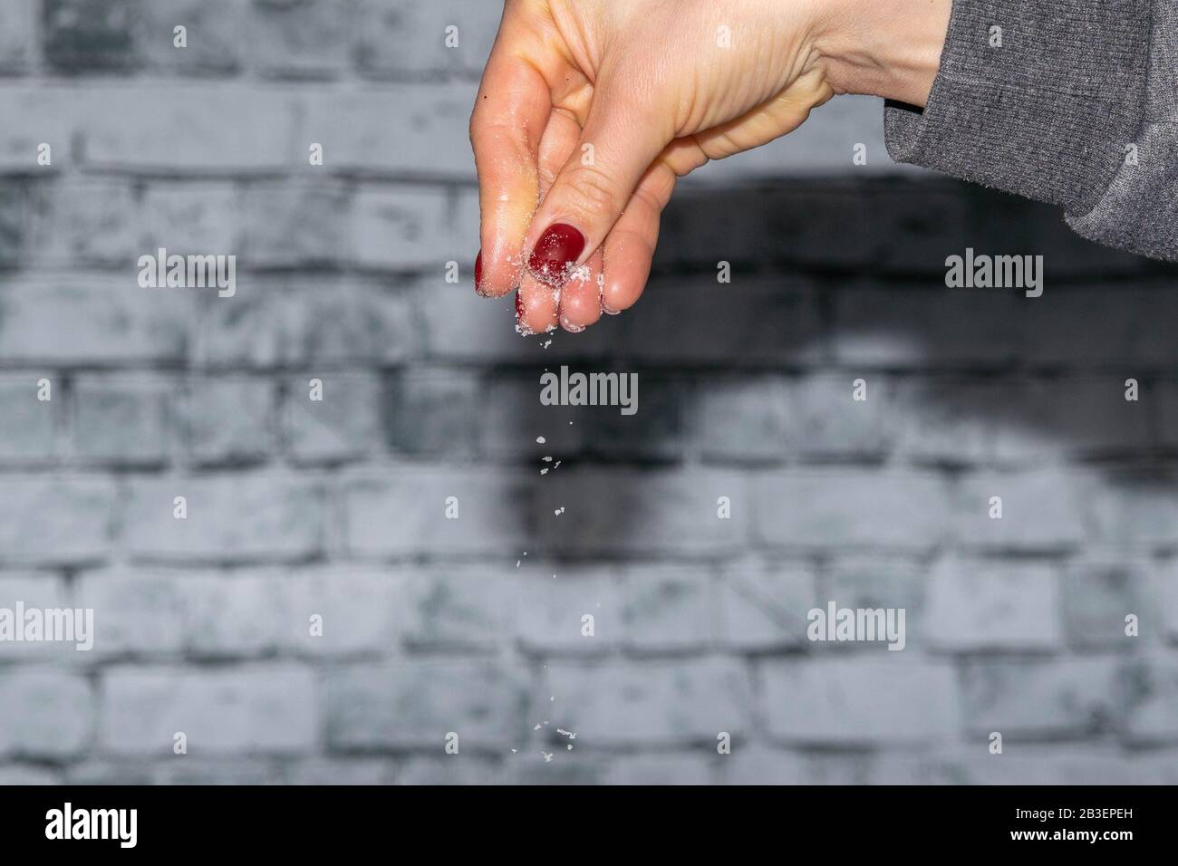 Women's hand is pouring salt Stock Photo - Alamy