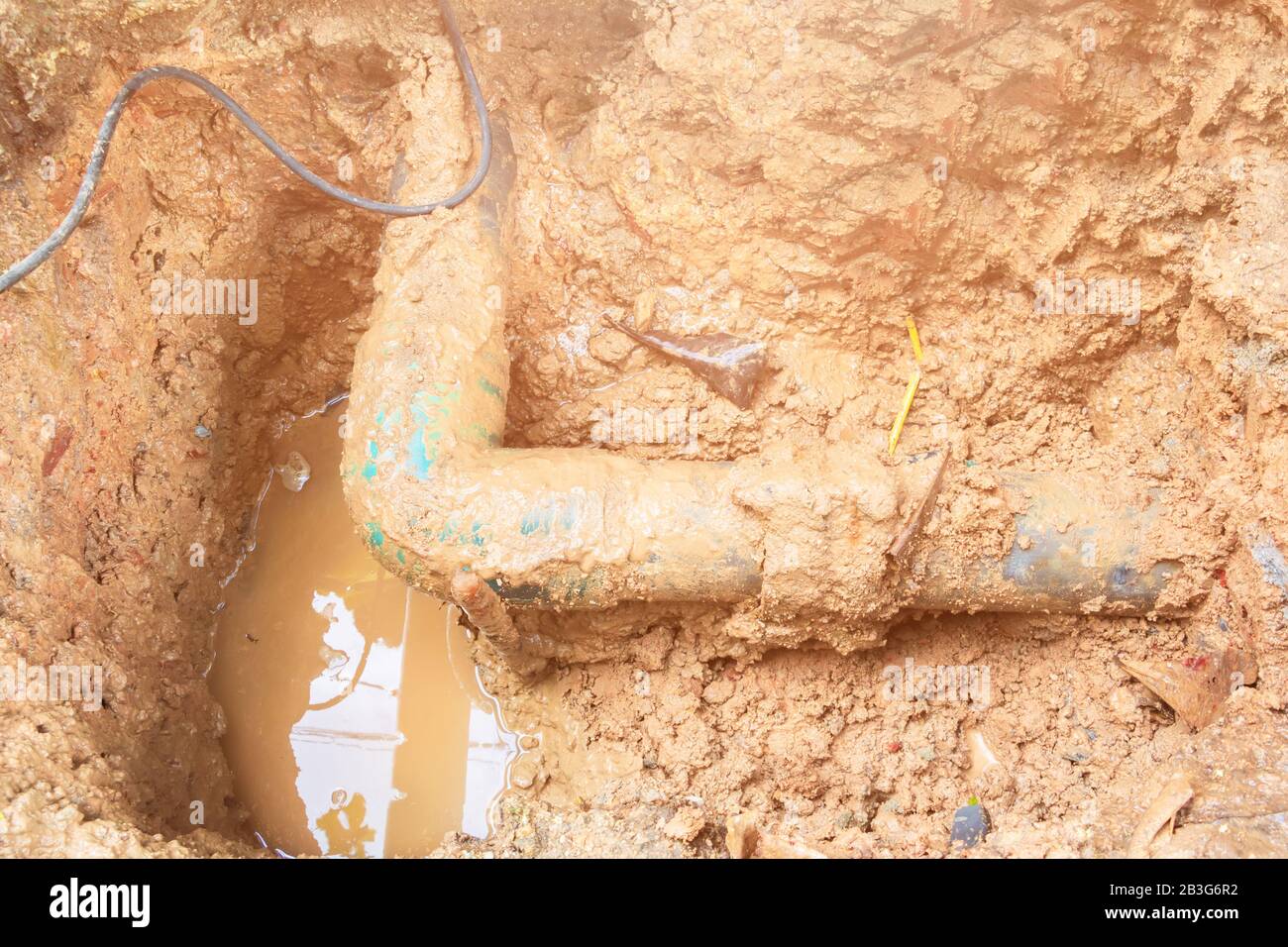 broken pipe in hole with water motion at roadside wait repair Stock ...