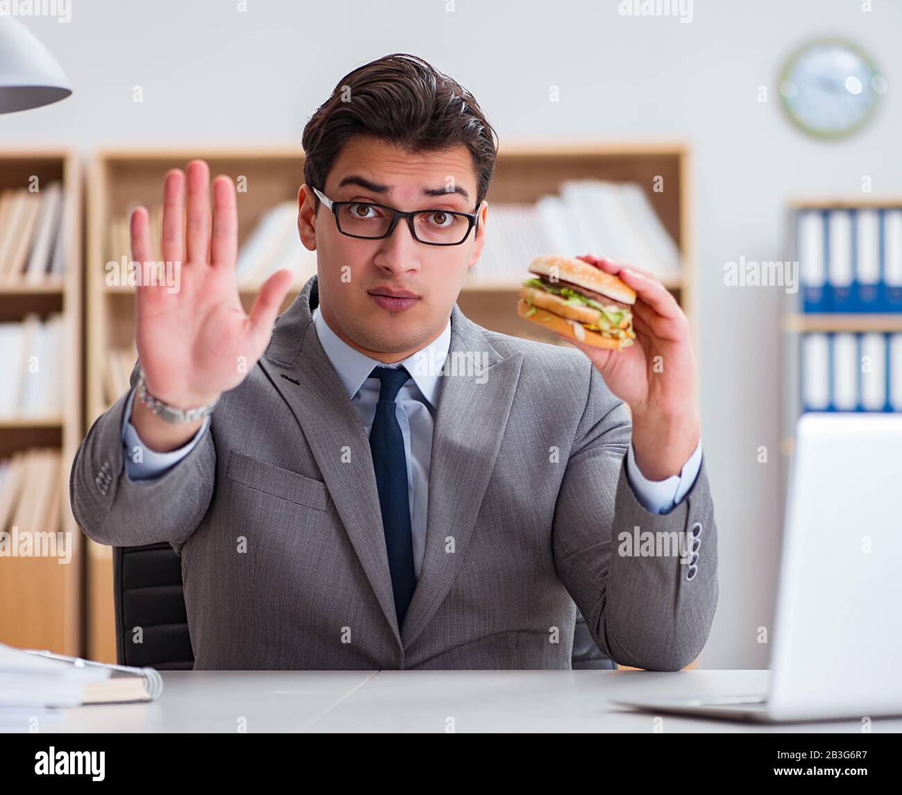 The hungry funny businessman eating junk food sandwich Stock Photo - Alamy