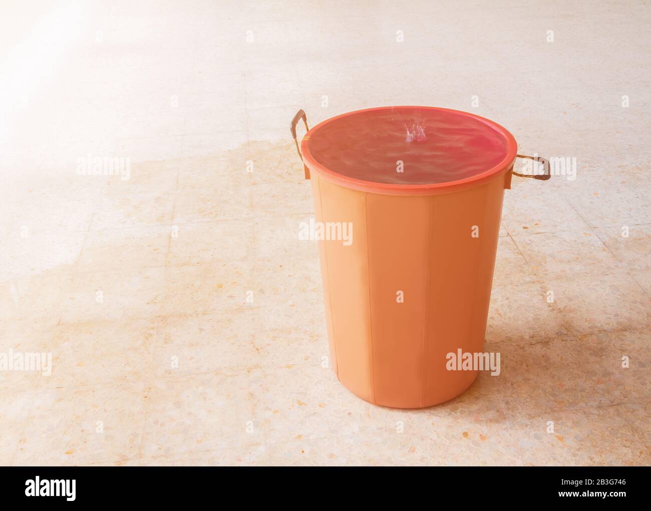 water leak drop interior office building in red bucket from Ceiling and ...