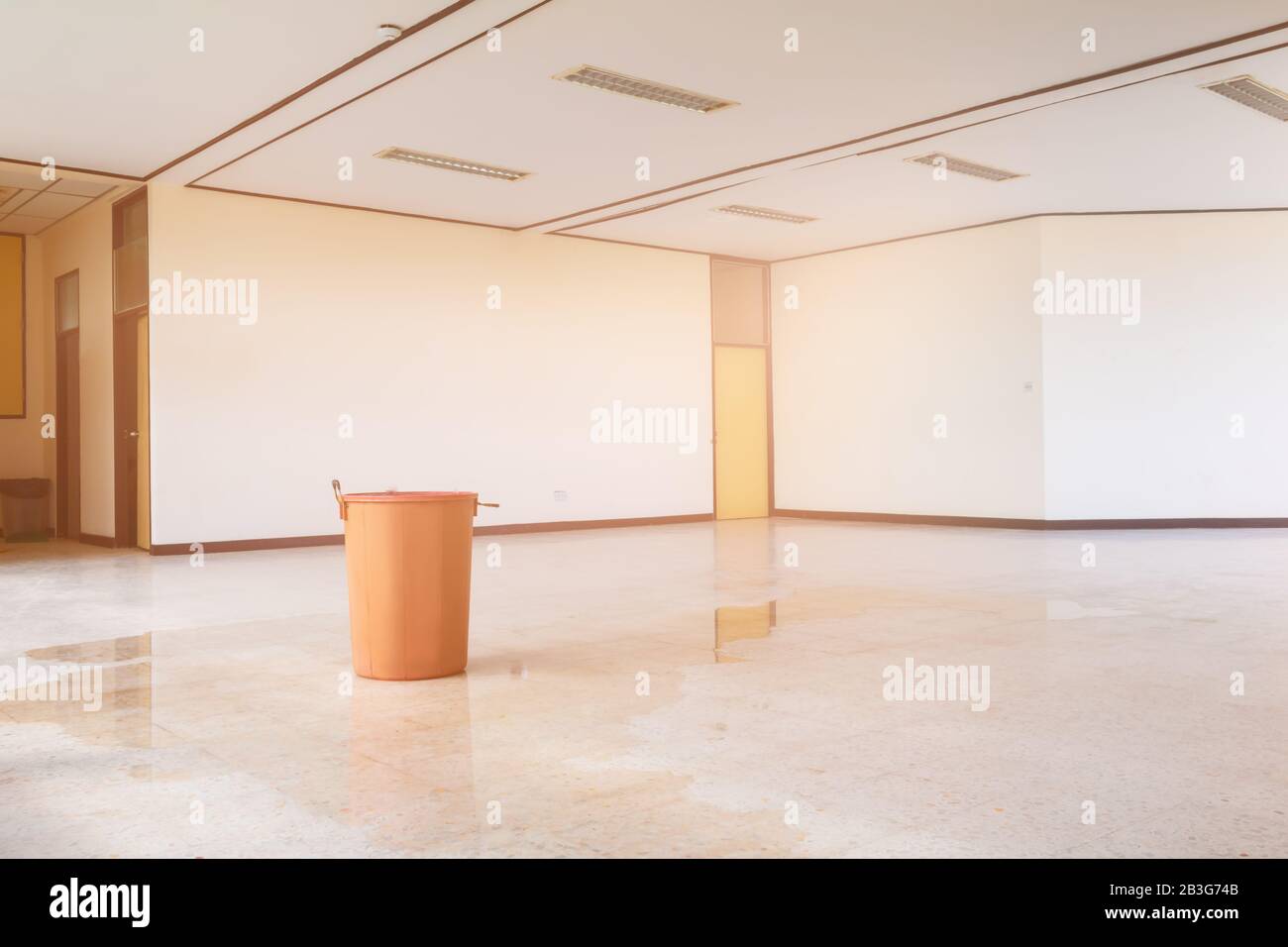 water leak drop interior office building in red bucket from Ceiling and ...