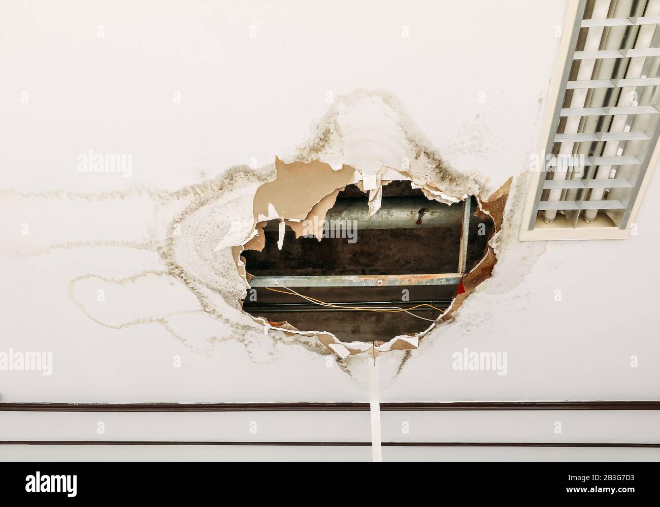 gypsum ceiling decay hole interior office building Stock Photo - Alamy