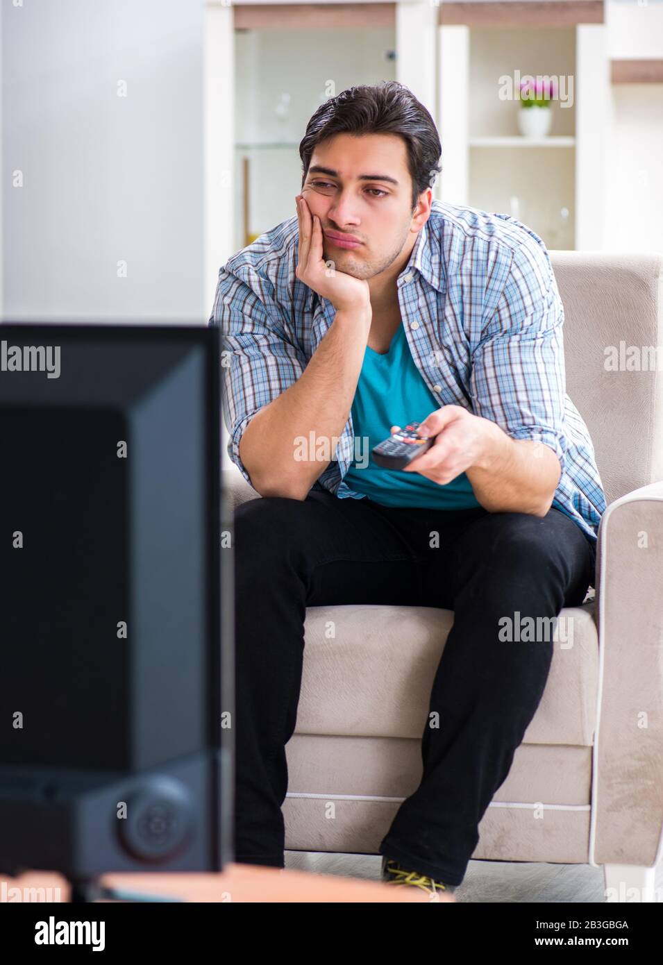 The man watching tv at home Stock Photo - Alamy