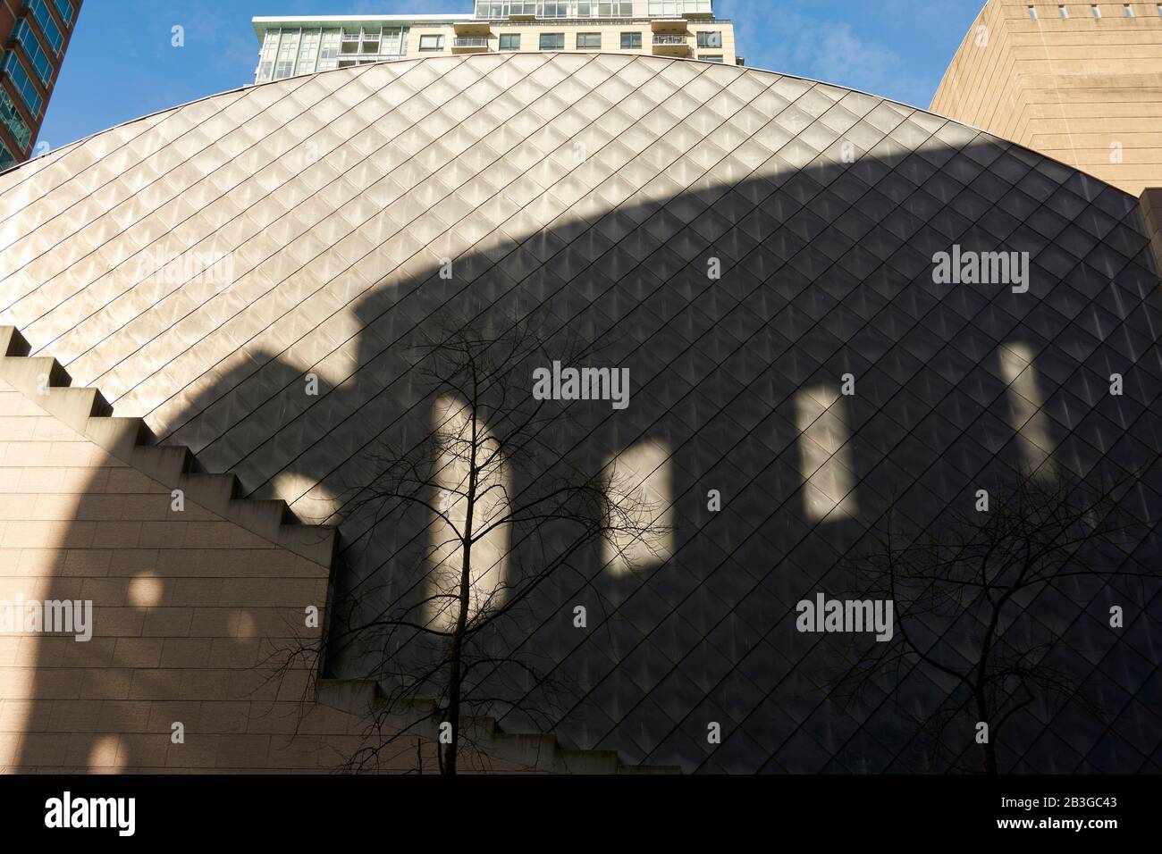Abstract looming architectural shadows cast on a modern building facade ...