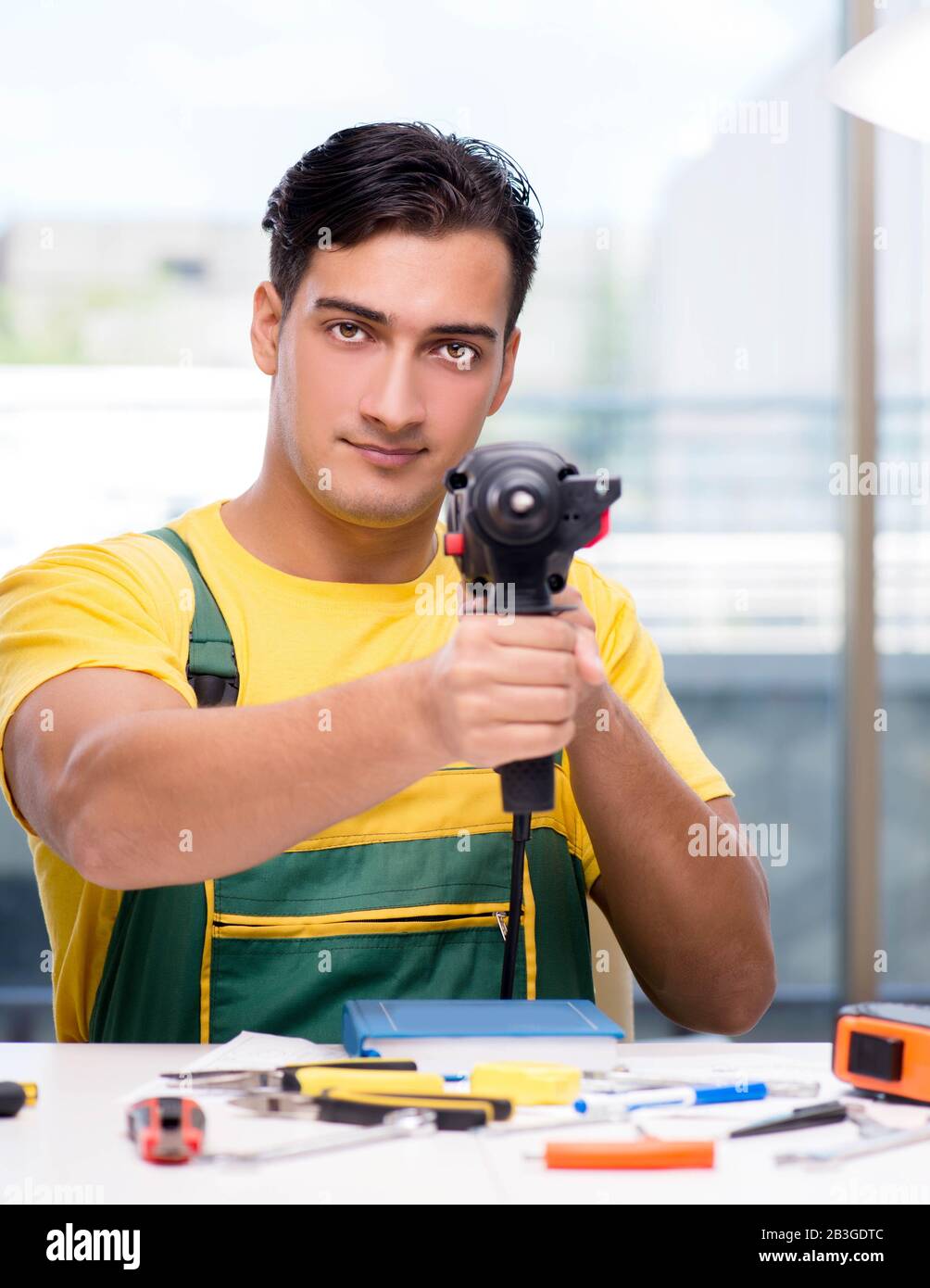 The construction worker sitting at the desk Stock Photo - Alamy