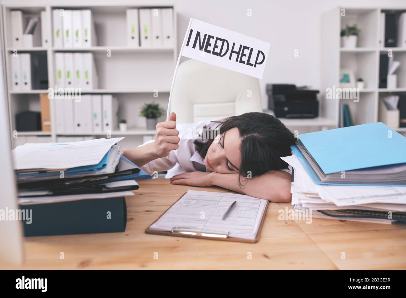 Tired office woman leaning on table with business documents and asking ...