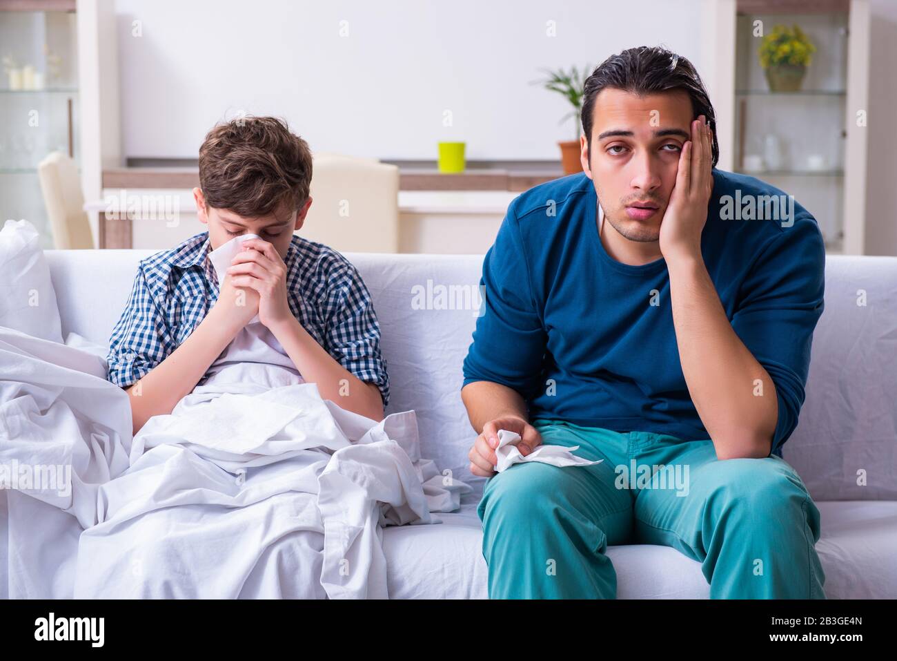 The young father caring for sick son Stock Photo - Alamy