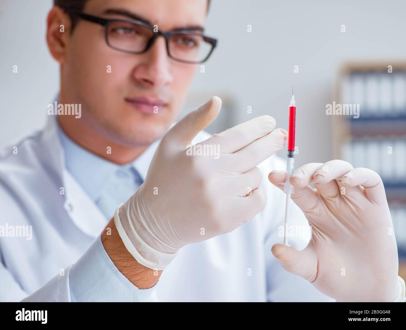 Cheerful nurse holding syringe hi-res stock photography and images - Alamy