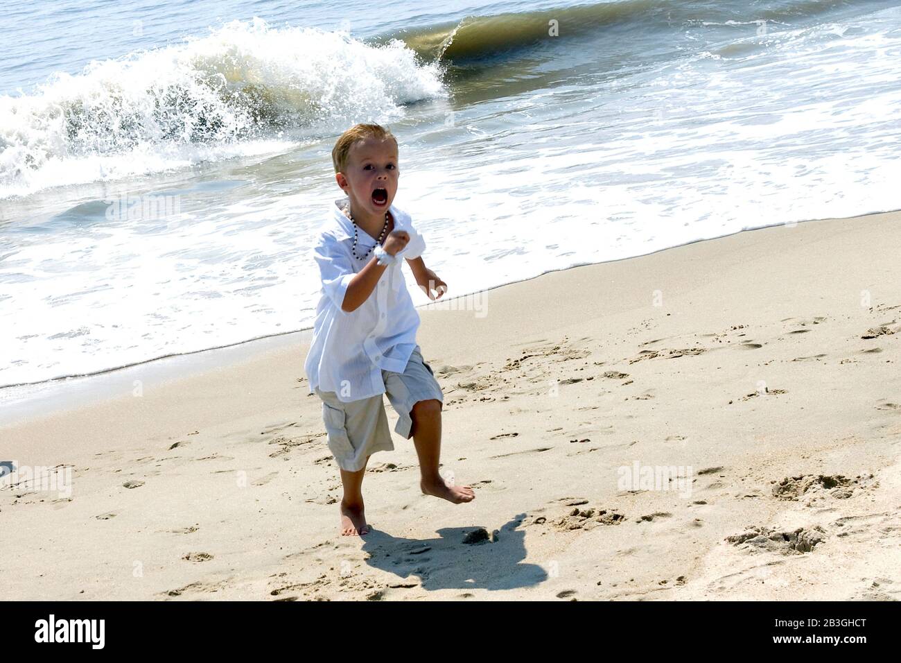 Boy running from waves hi-res stock photography and images - Alamy