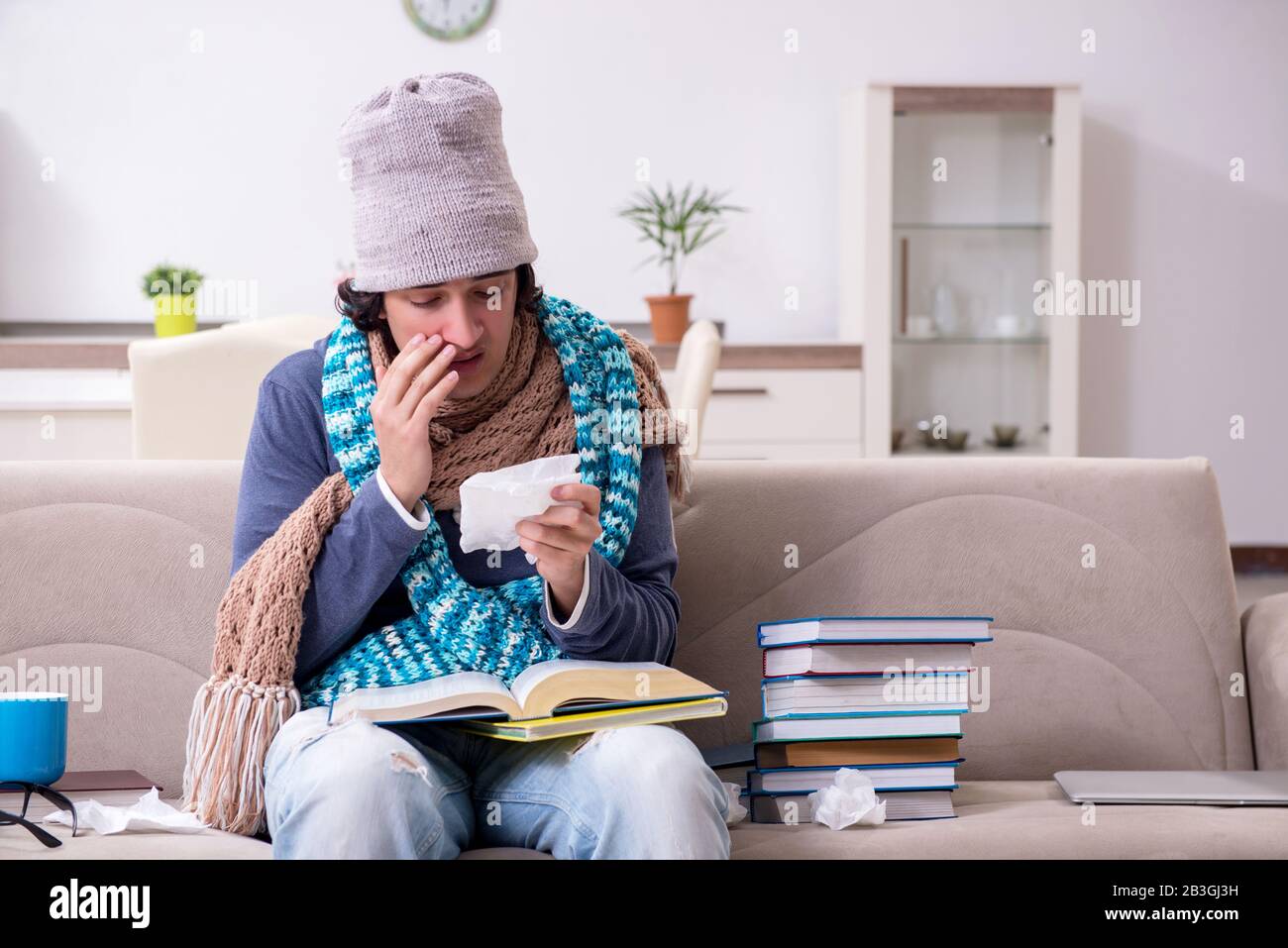 The sick male student suffering at home Stock Photo - Alamy