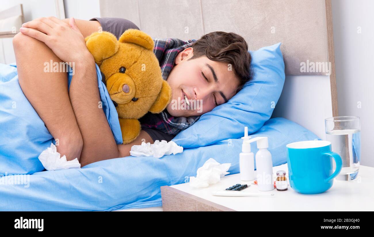 The sick man with flu lying in the bed Stock Photo - Alamy