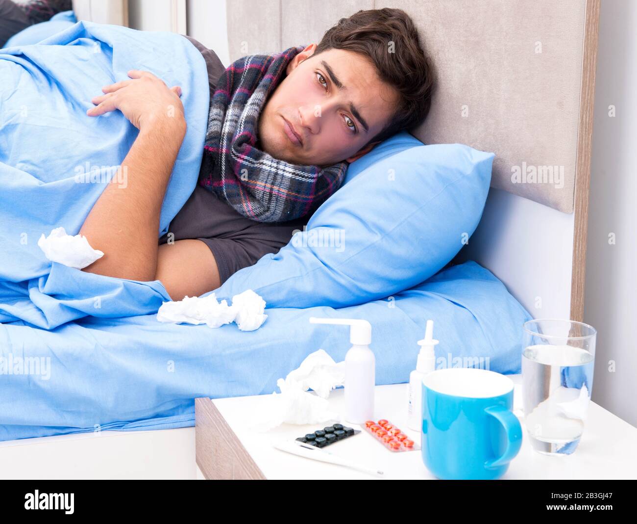 The sick man with flu lying in the bed Stock Photo - Alamy