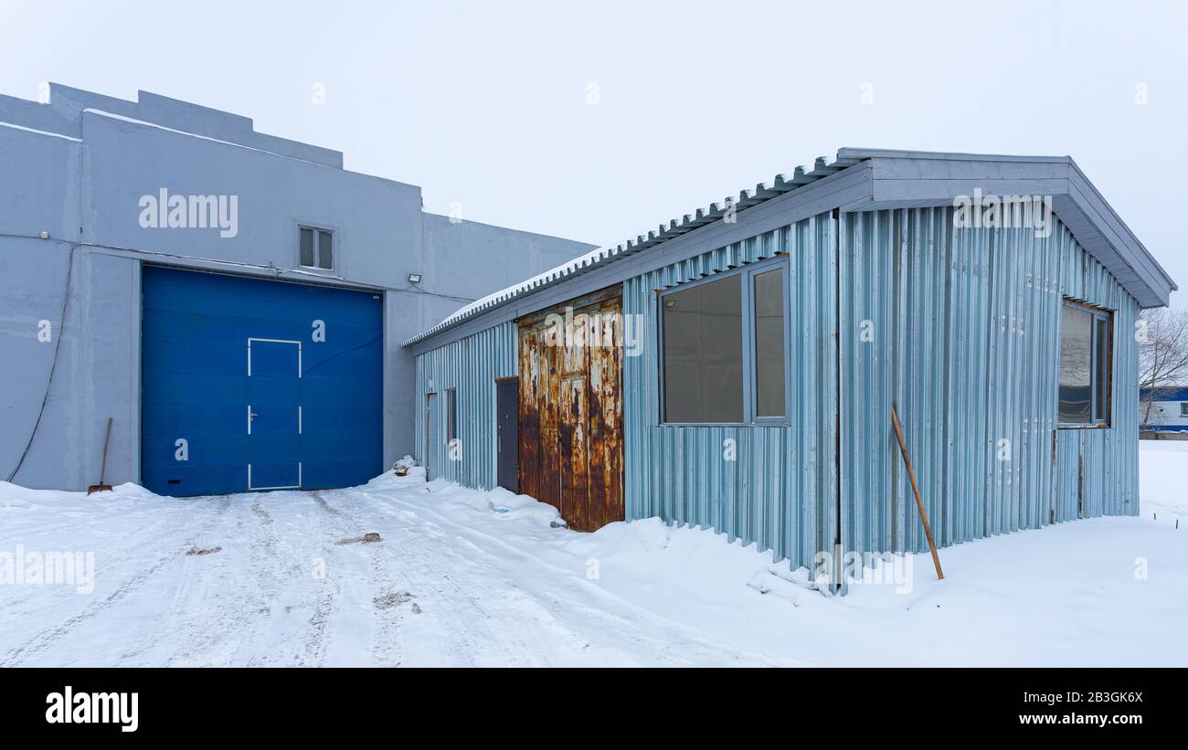 A large metal industrial warehouse for storing goods in winter day ...