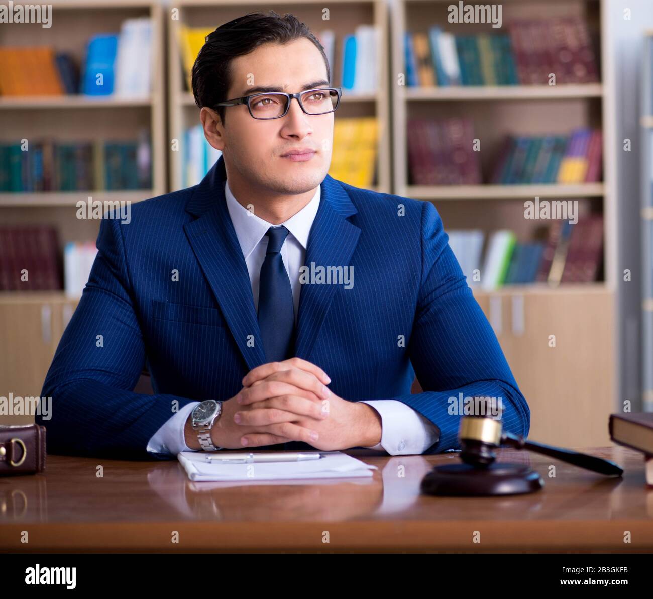The handsome judge with gavel sitting in courtroom Stock Photo - Alamy