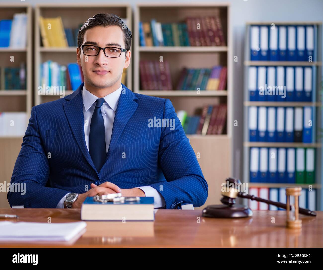 The handsome judge with gavel sitting in courtroom Stock Photo - Alamy