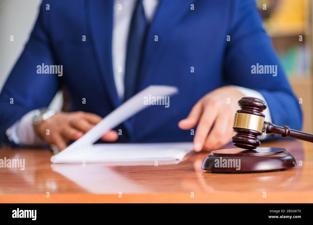 The handsome judge with gavel sitting in courtroom Stock Photo - Alamy