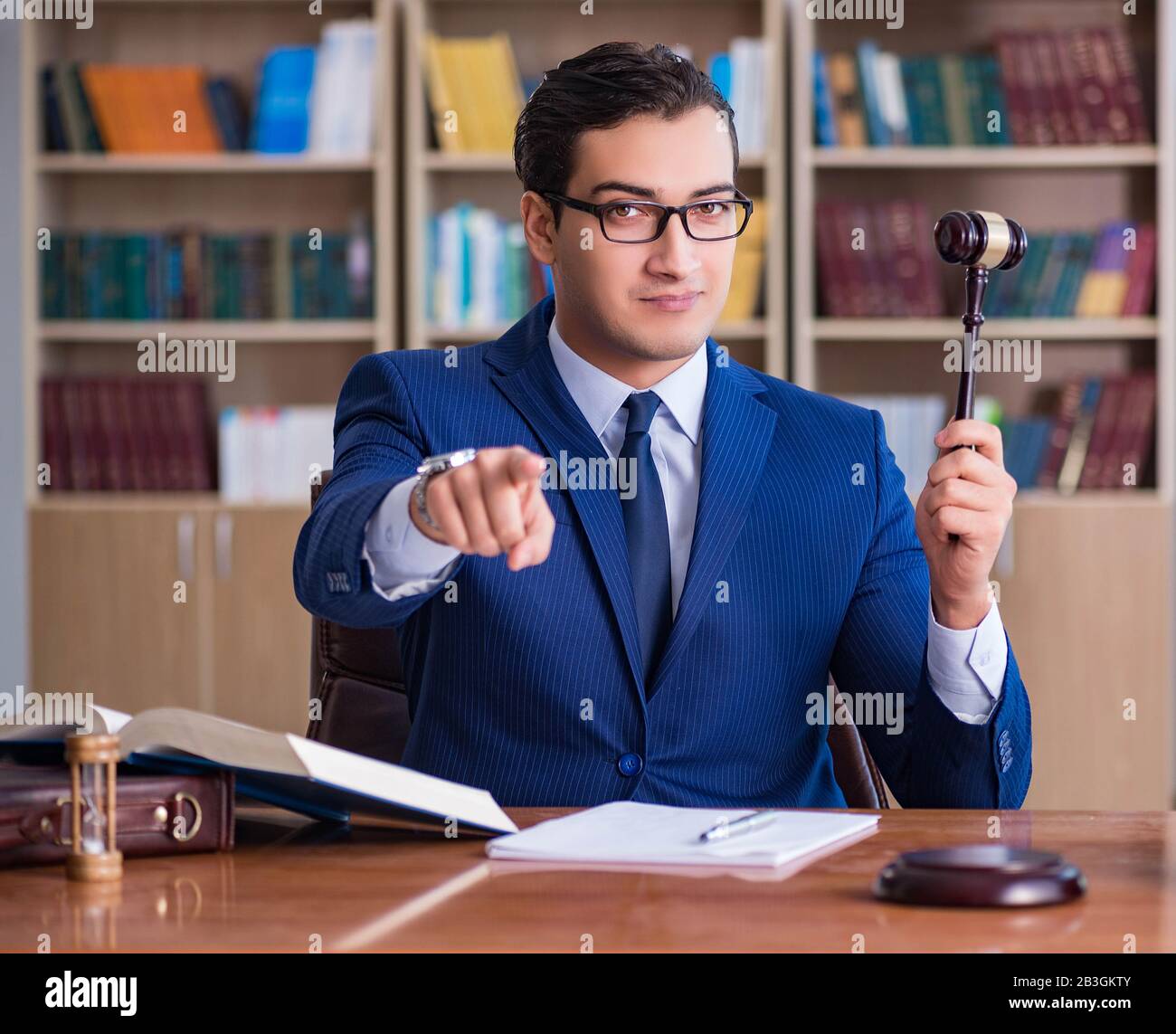 The handsome judge with gavel sitting in courtroom Stock Photo - Alamy