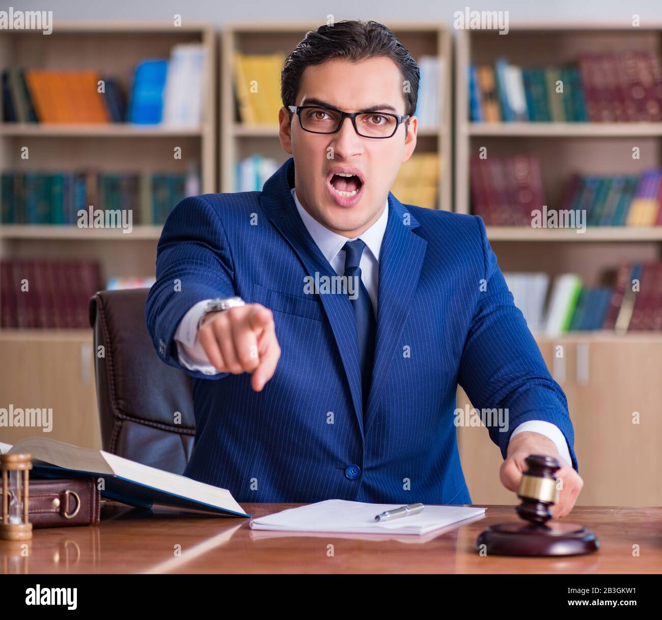 The handsome judge with gavel sitting in courtroom Stock Photo - Alamy