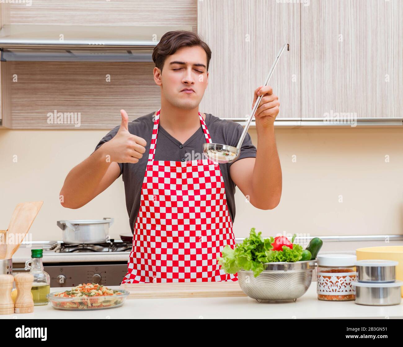 The man male cook preparing food in kitchen Stock Photo - Alamy