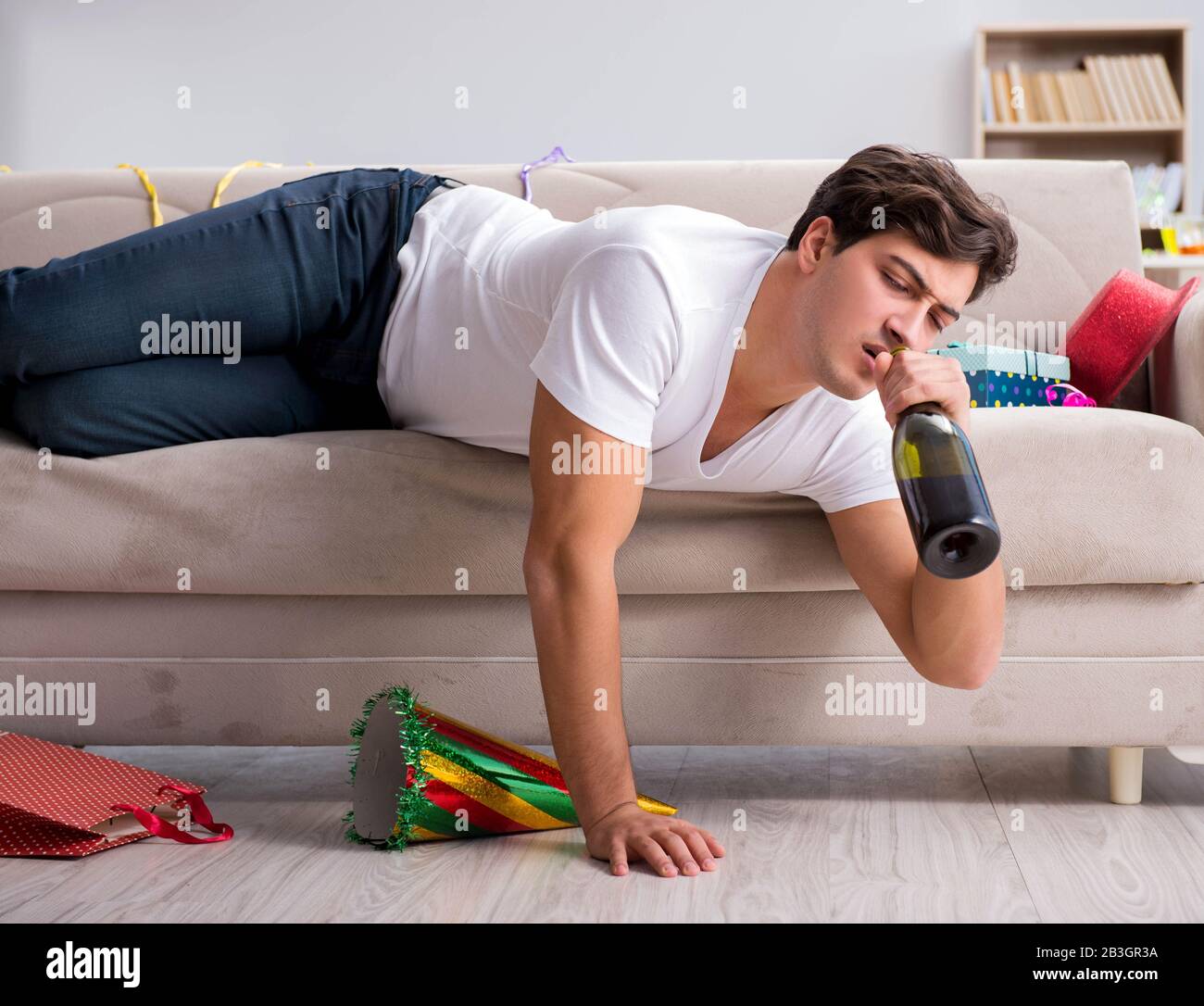 The man at home after heavy partying Stock Photo - Alamy