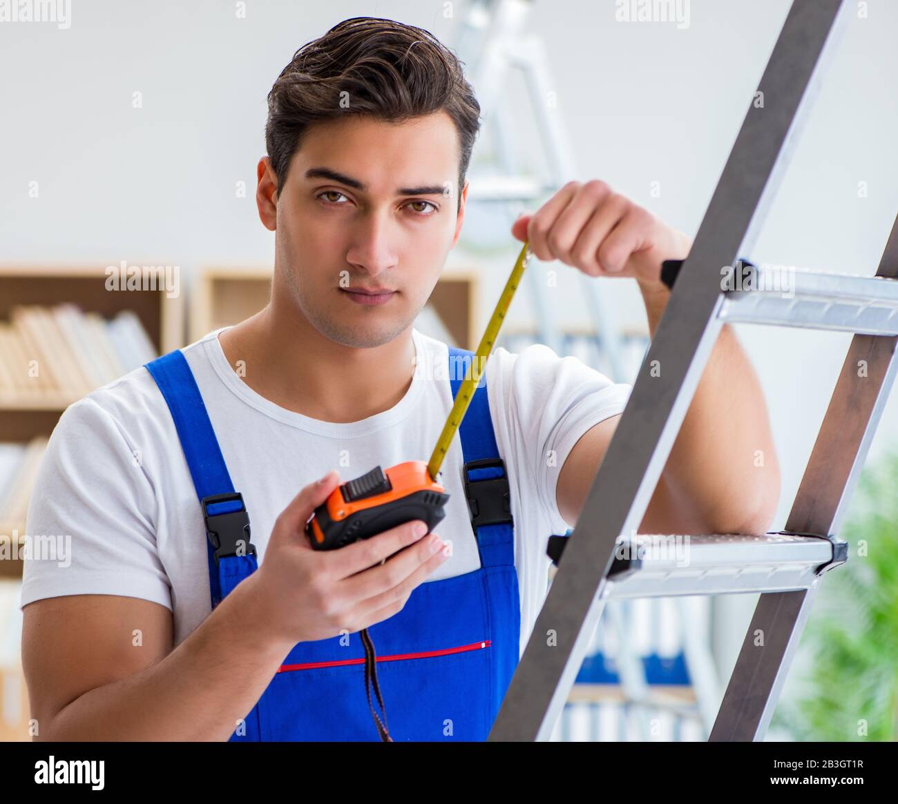 The repairman working with measurement tape Stock Photo - Alamy