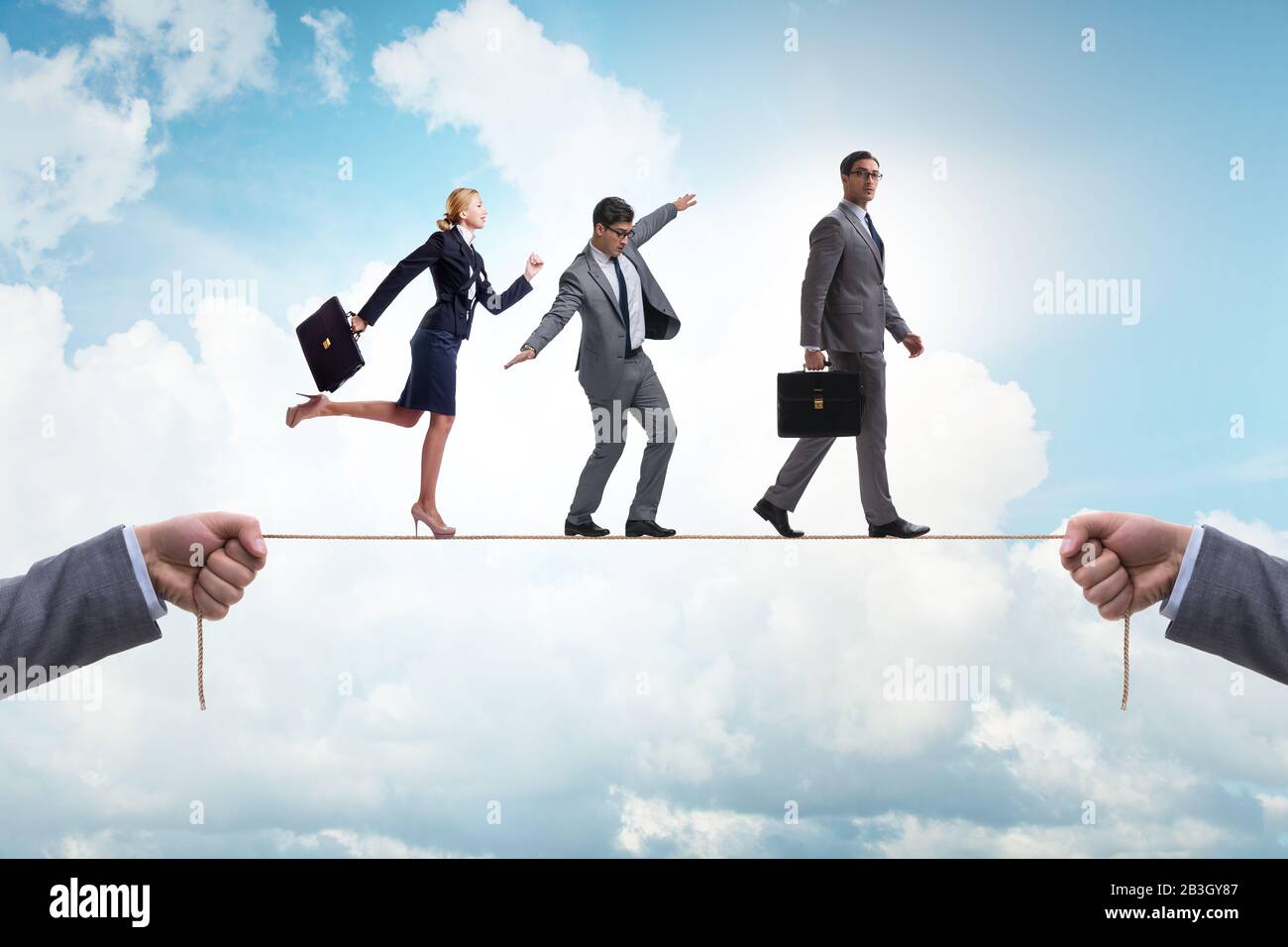 The business people walking on tight rope Stock Photo - Alamy