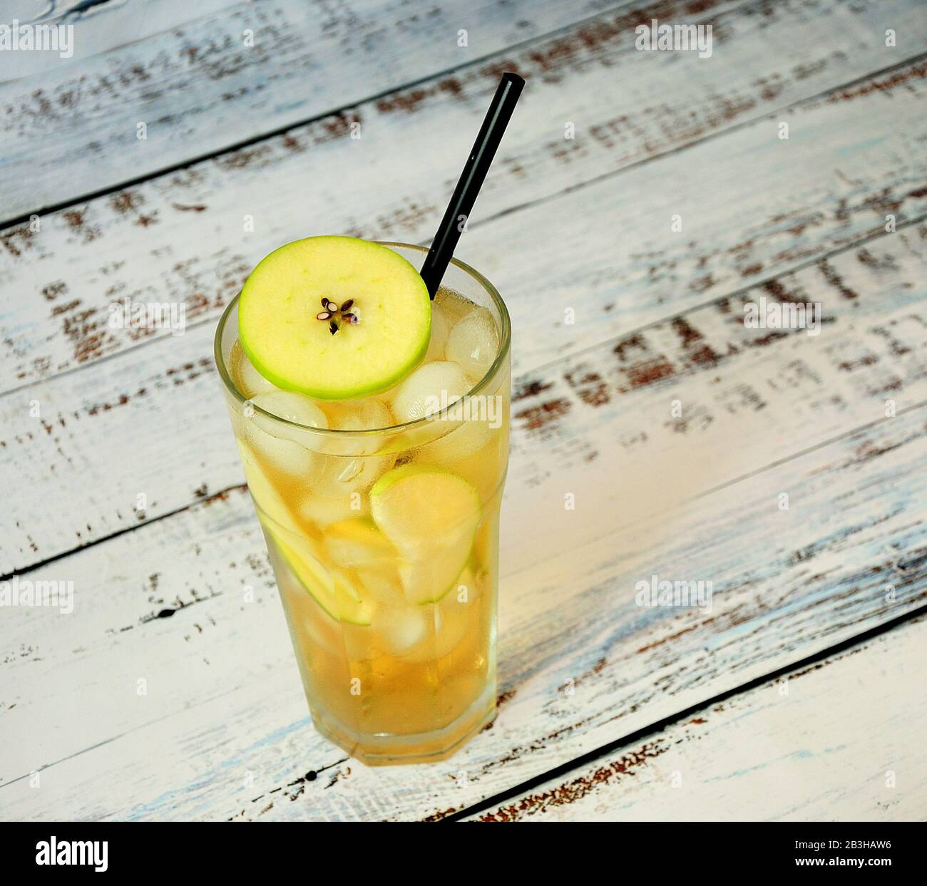 A tall glass glass of fruit juice with a soldier and a slice of ripe ...