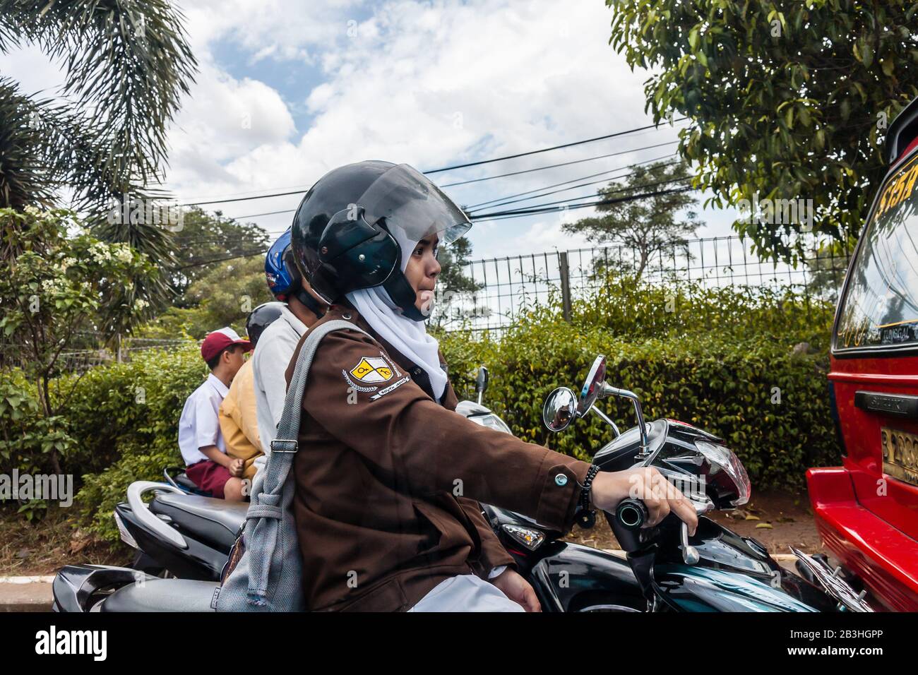 Indonesian young woman in hijab driving a scooter, Yogyakarta Stock ...