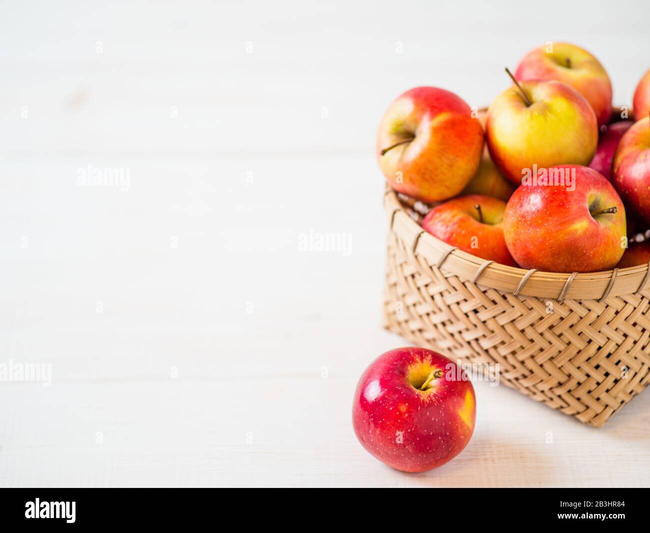 Apples harvest concept. Braided bamboo basket with red apples on white ...