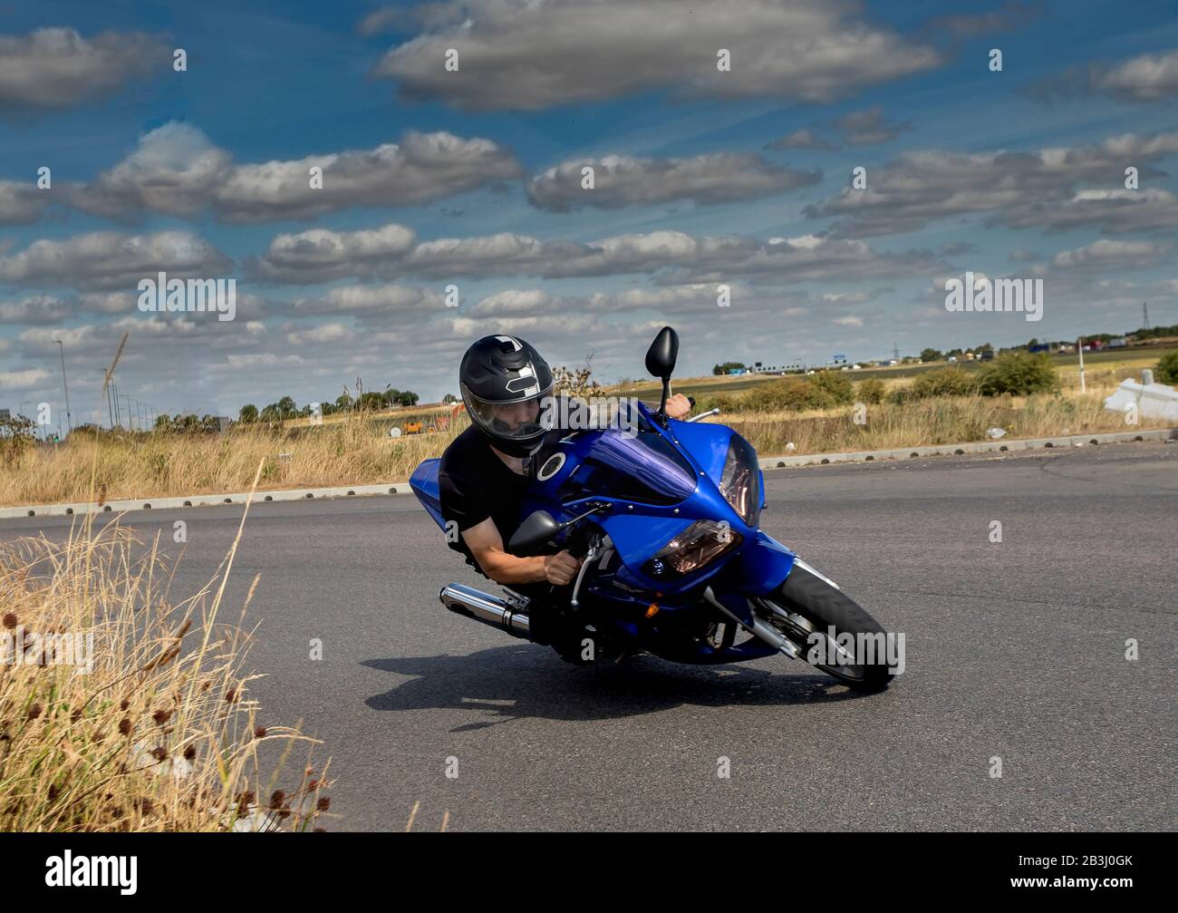 Boy on motorcycle driving fast on the corner, Street race Stock Photo ...