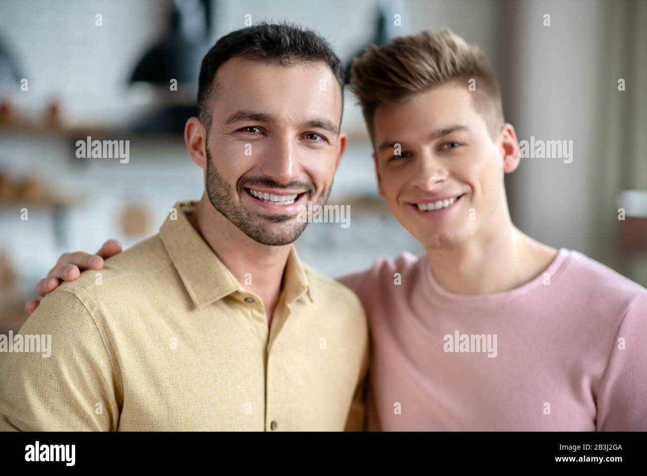 Two young men smiling happily and looking good Stock Photo - Alamy