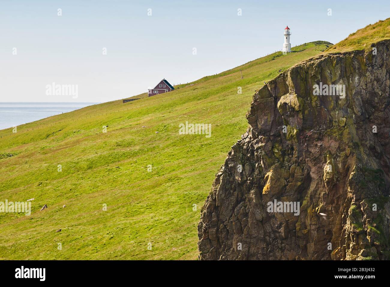 Mykines lighthouse and cliffs on Faroe islands. Hiking landmark ...