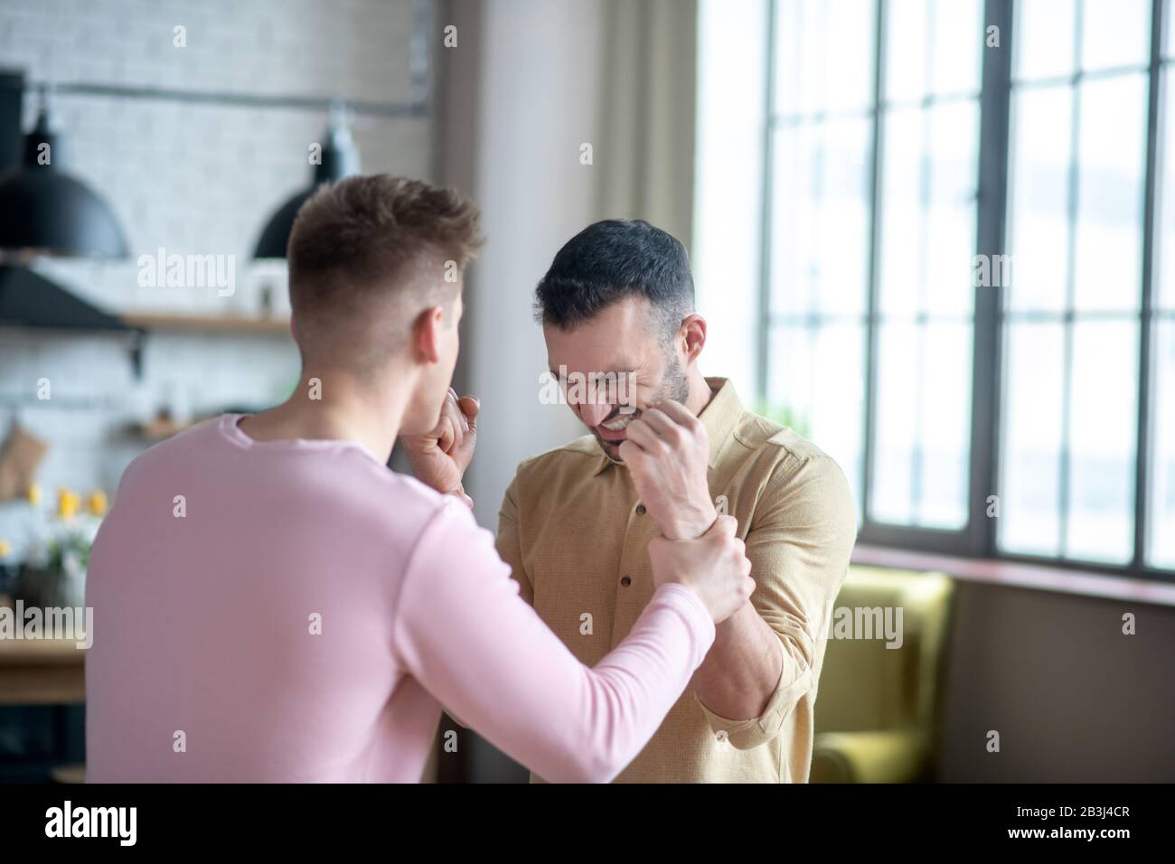 Two young men fighting and looking agressive Stock Photo - Alamy