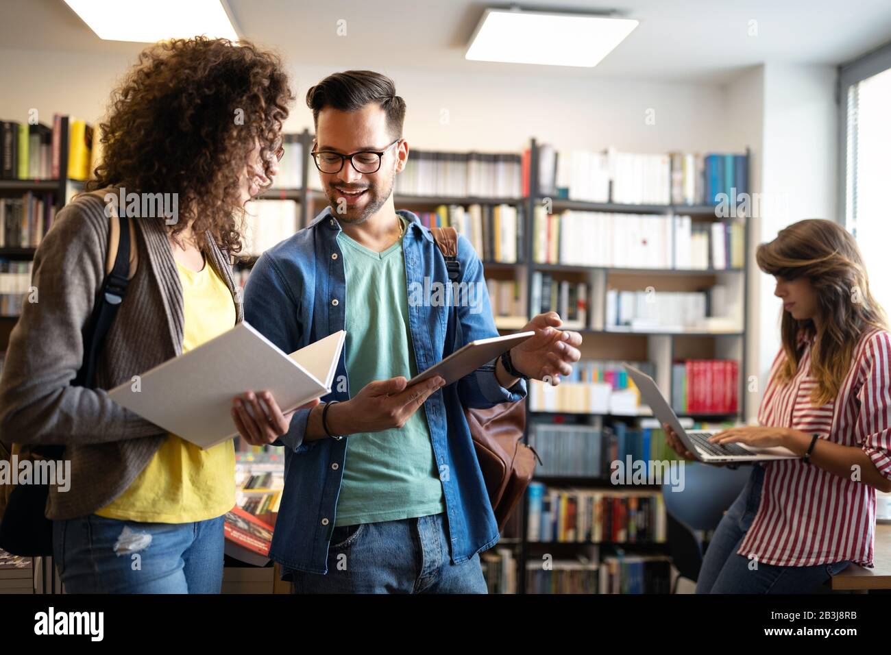 Group of college students studying in the school library Stock Photo ...