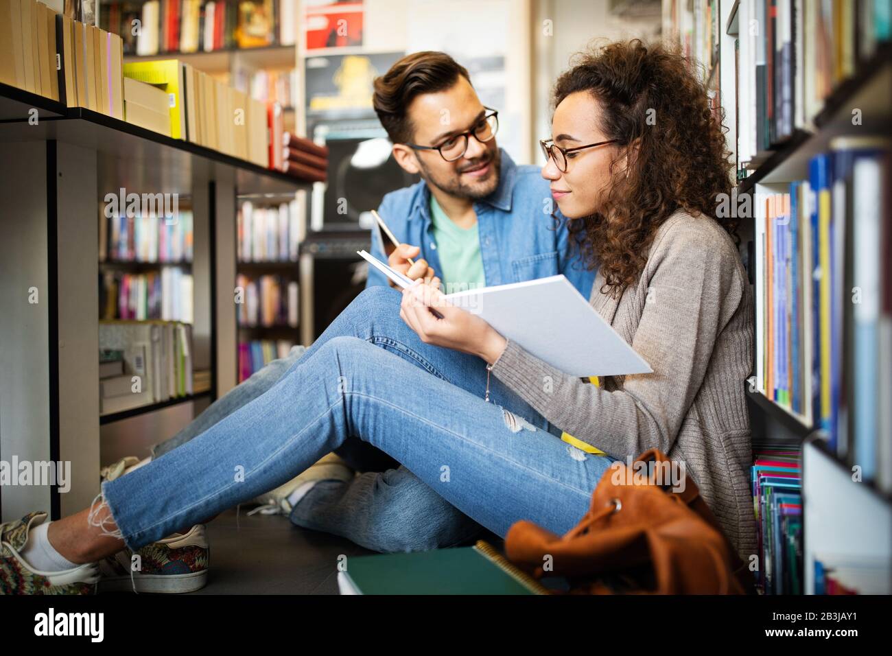 Group of college students studying in the school library Stock Photo ...