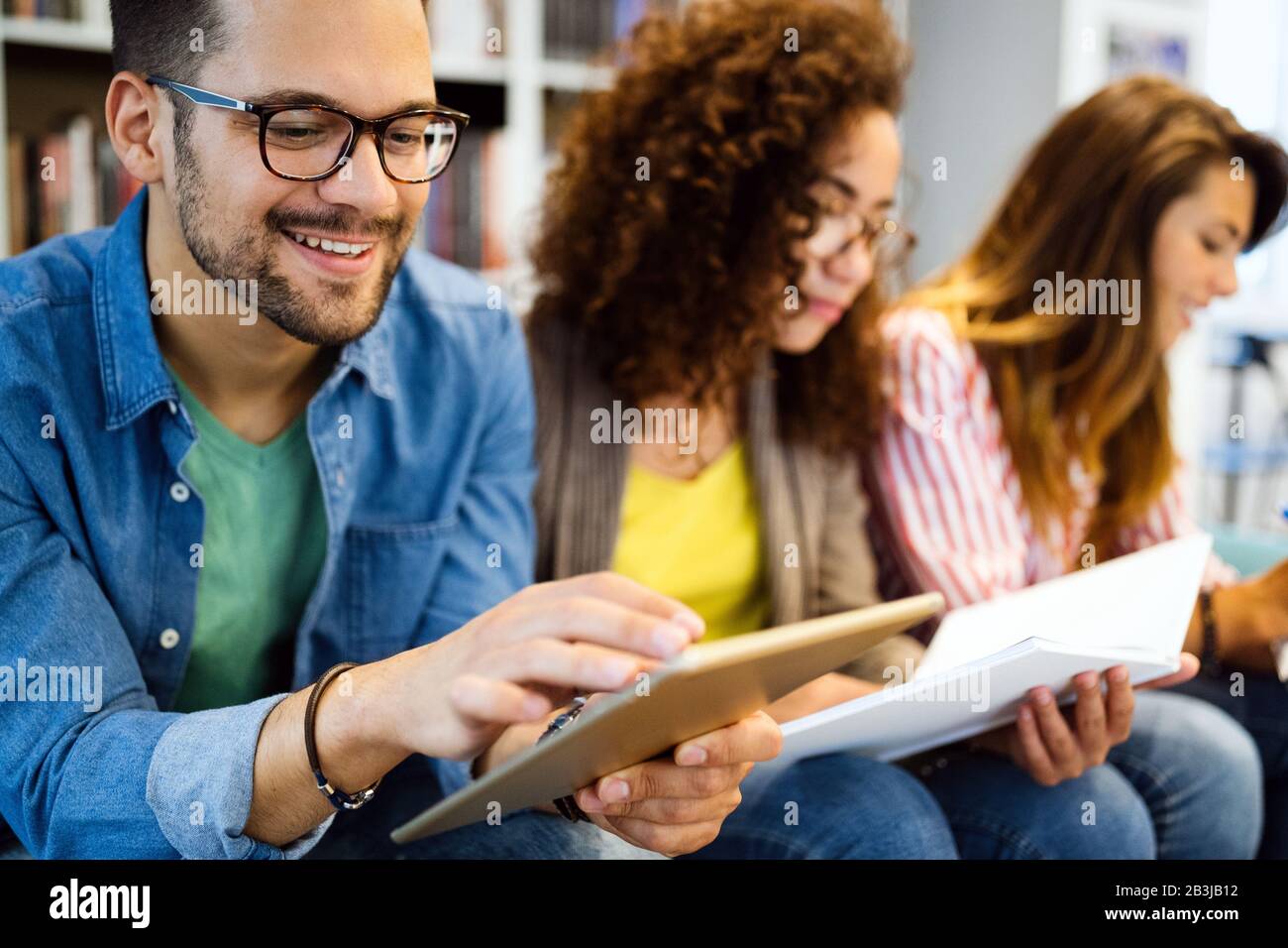 Group of college students studying in the school library Stock Photo ...