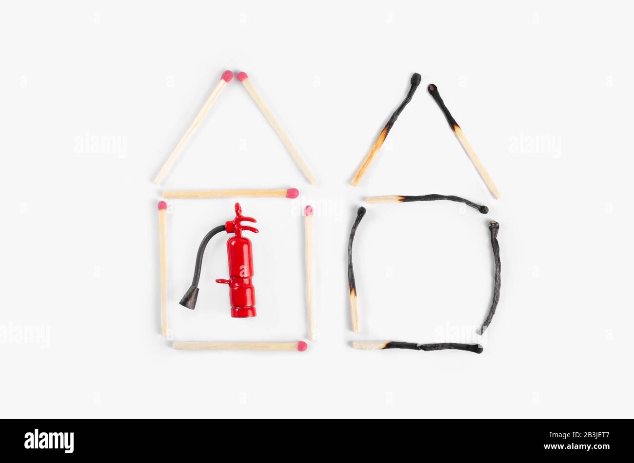 Two houses made of burnt and unburned matches with a miniature fire ...