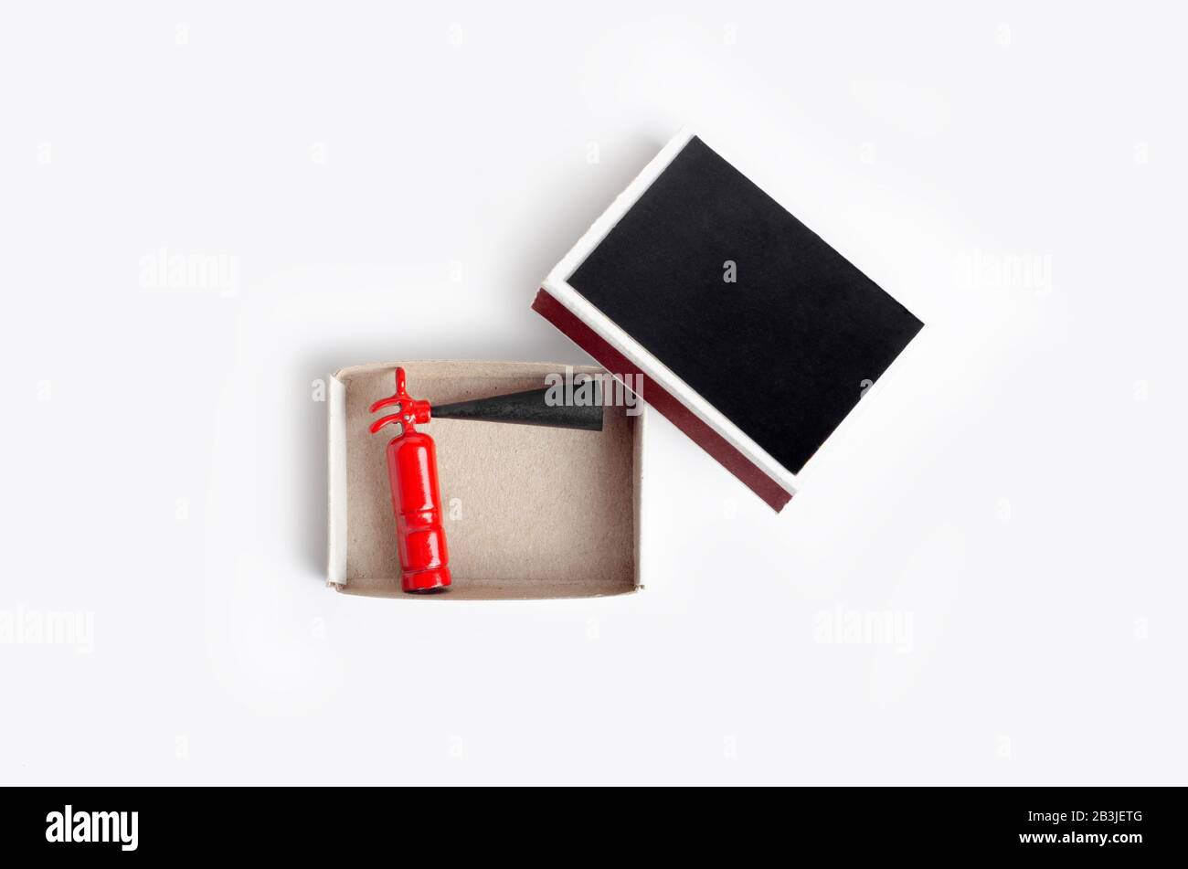 Small size fire extinguisher inside an opened match box, top view on ...