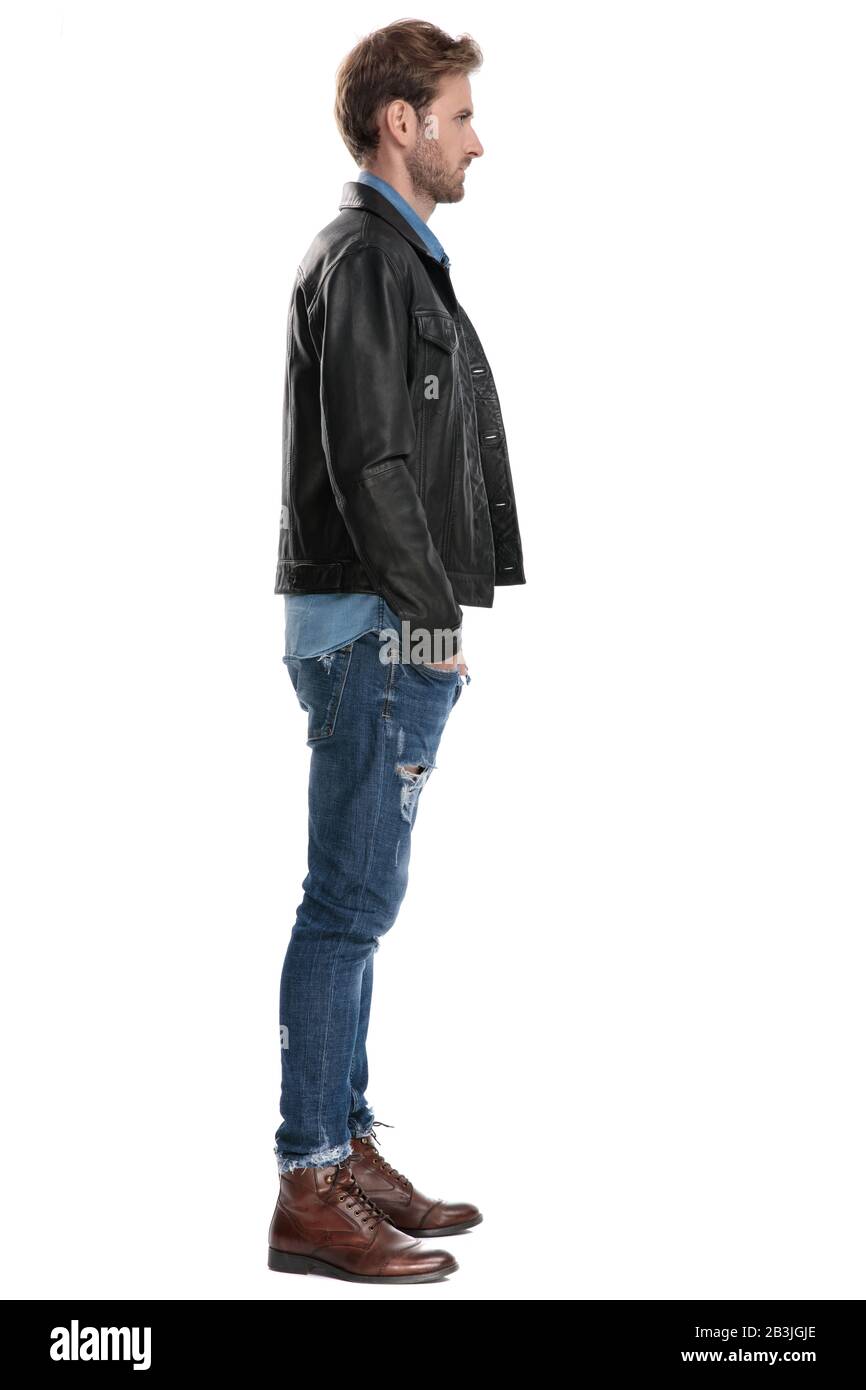 side view of a attractive casual man with black leather jacket standing ...