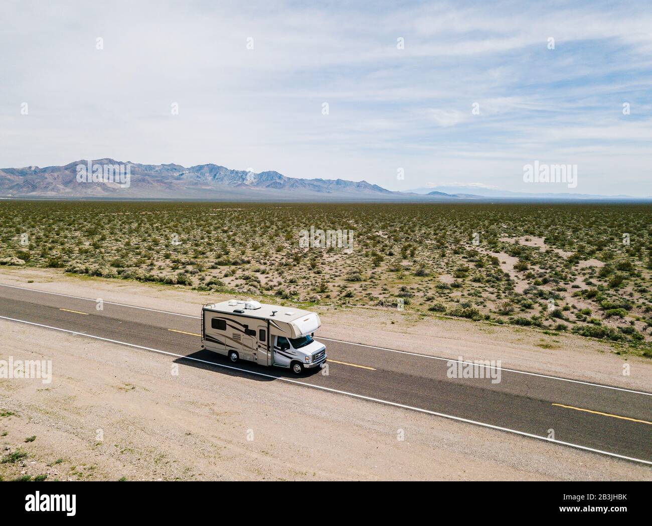 Aerial view of a motorhome driving on a highway in the desert of USA ...