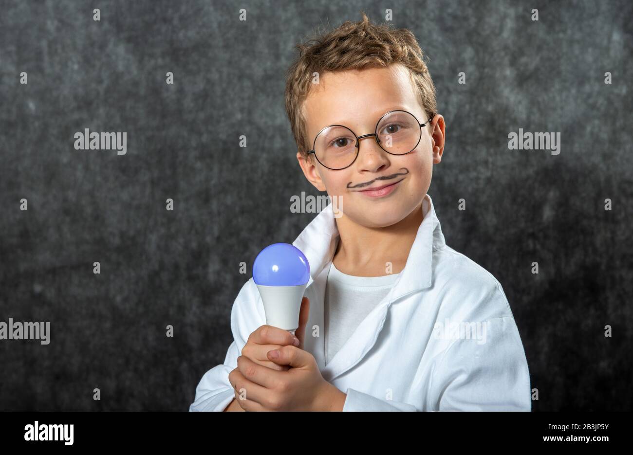 cute smiling child boy with a light bulb Stock Photo - Alamy