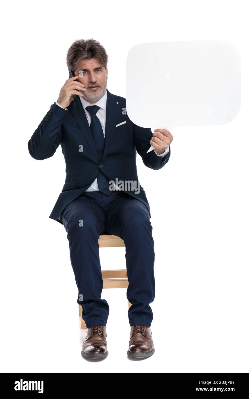 beautiful formal business man with navy suit is sitting with a speech ...