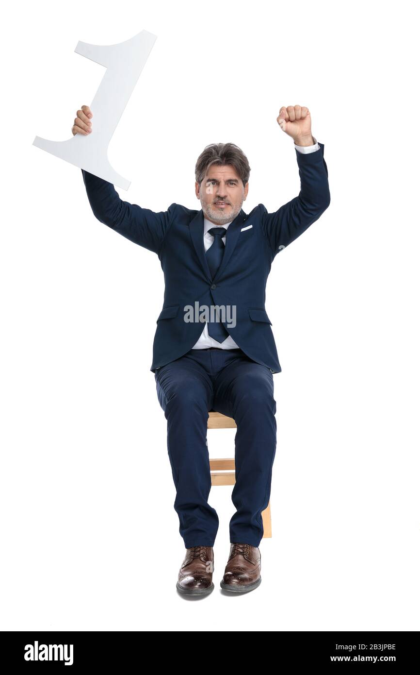 brown haired formal business man with navy suit is sitting holding a ...
