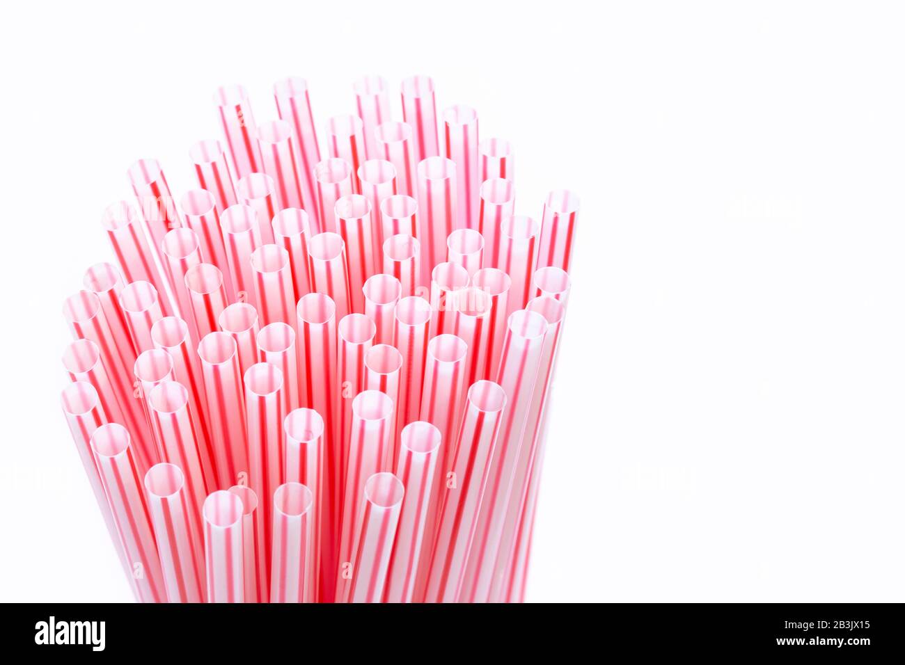 Plastic straws with red and white stripes in a bunch isolated on a ...