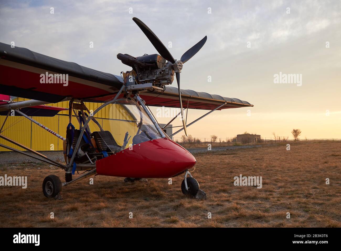 Ultralight two-seater airplane with a propeller stands on the airfield ...
