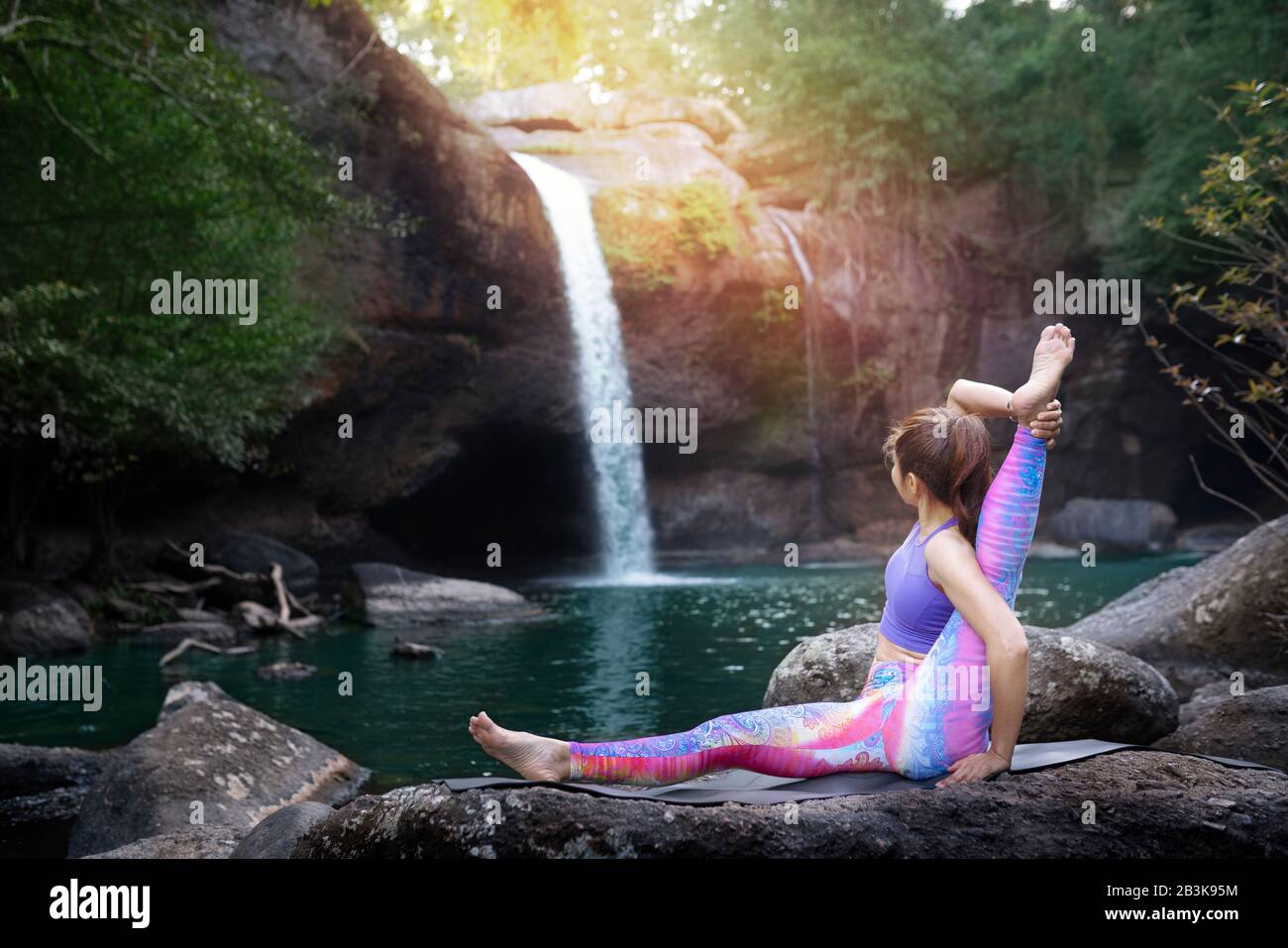 woman practice yoga in front of waterfall Stock Photo - Alamy