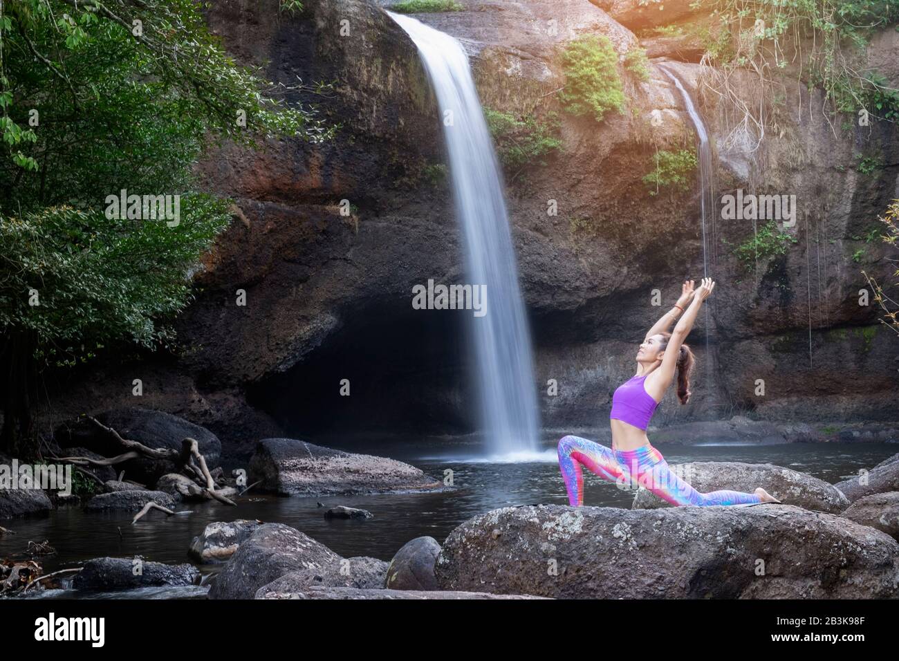 woman practice yoga in front of waterfall Stock Photo - Alamy
