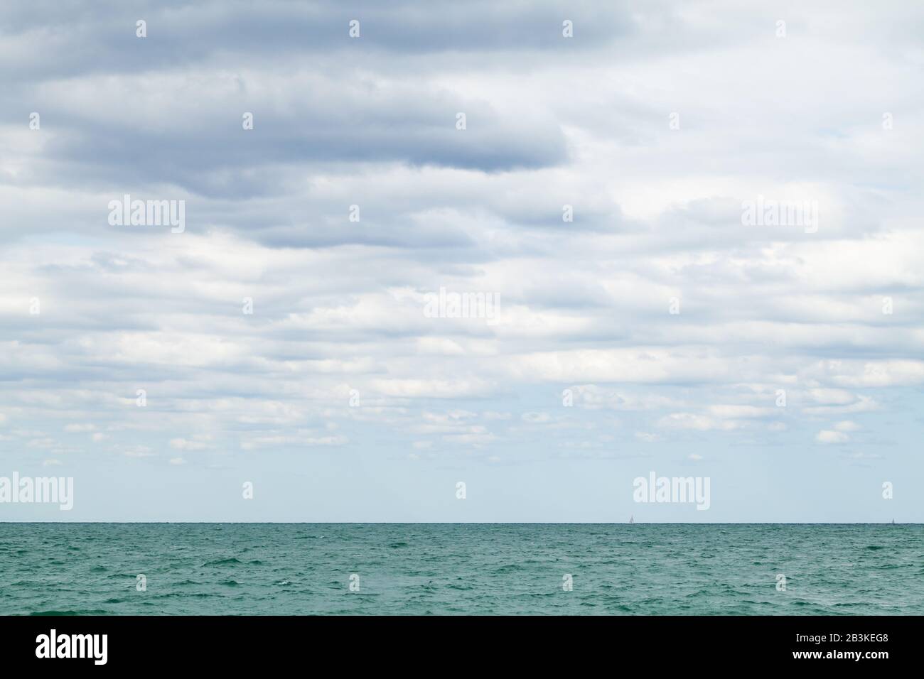 Landscape photo with white clouds and blue sea water at daytime ...